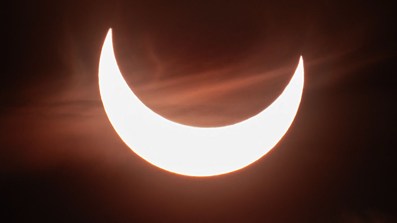 See the sun transform into a fiery crescent in breathtaking photos of ...