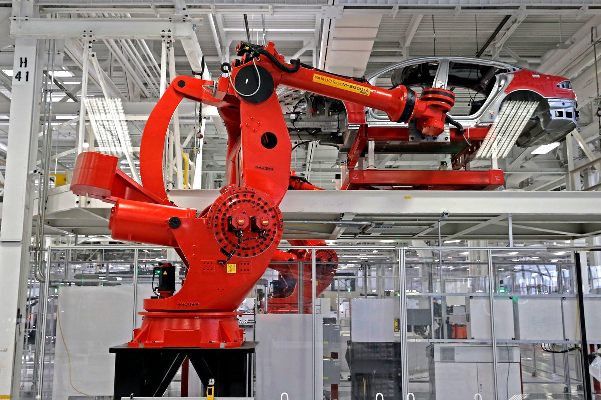 Tesla factory technician sues for $51 million after assembly-line robot ...