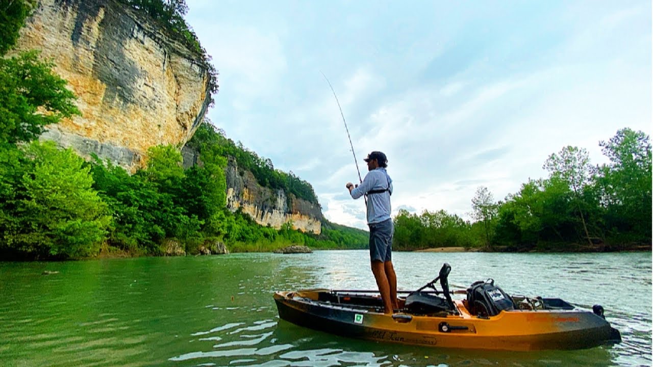 Kayak fishing gorgeous river deep in the mountains
