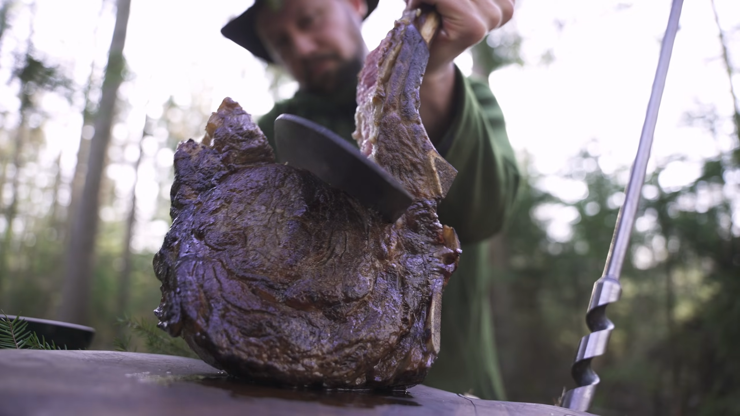 XXL Tomahawk Steak Grilled Hanging from a Tree