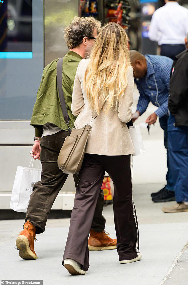 Elle Macpherson's hair extensions are exposed as she heads out with her ...