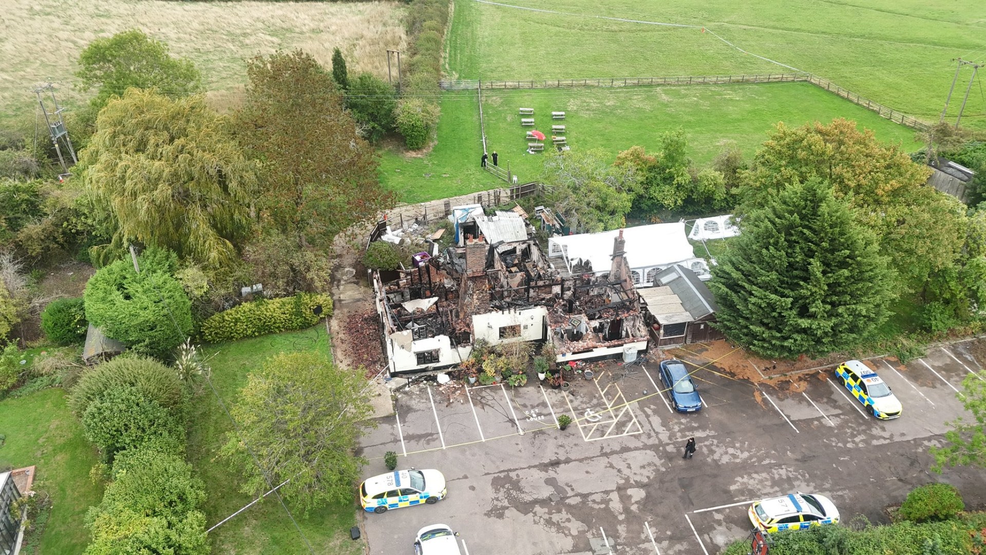 Crossbow man dies after police standoff at fiery pub