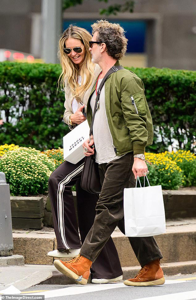 Elle Macpherson's hair extensions are exposed as she heads out with her ...