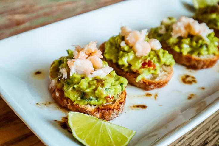 Lobster avocado crostini with black garlic butter