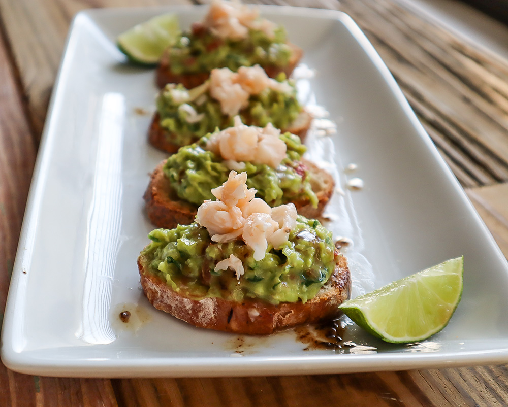 Lobster avocado crostini with black garlic butter