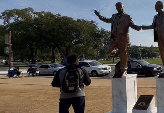 Residents Walk By Mysterious New Statue of Trump and Epstein Holding ...