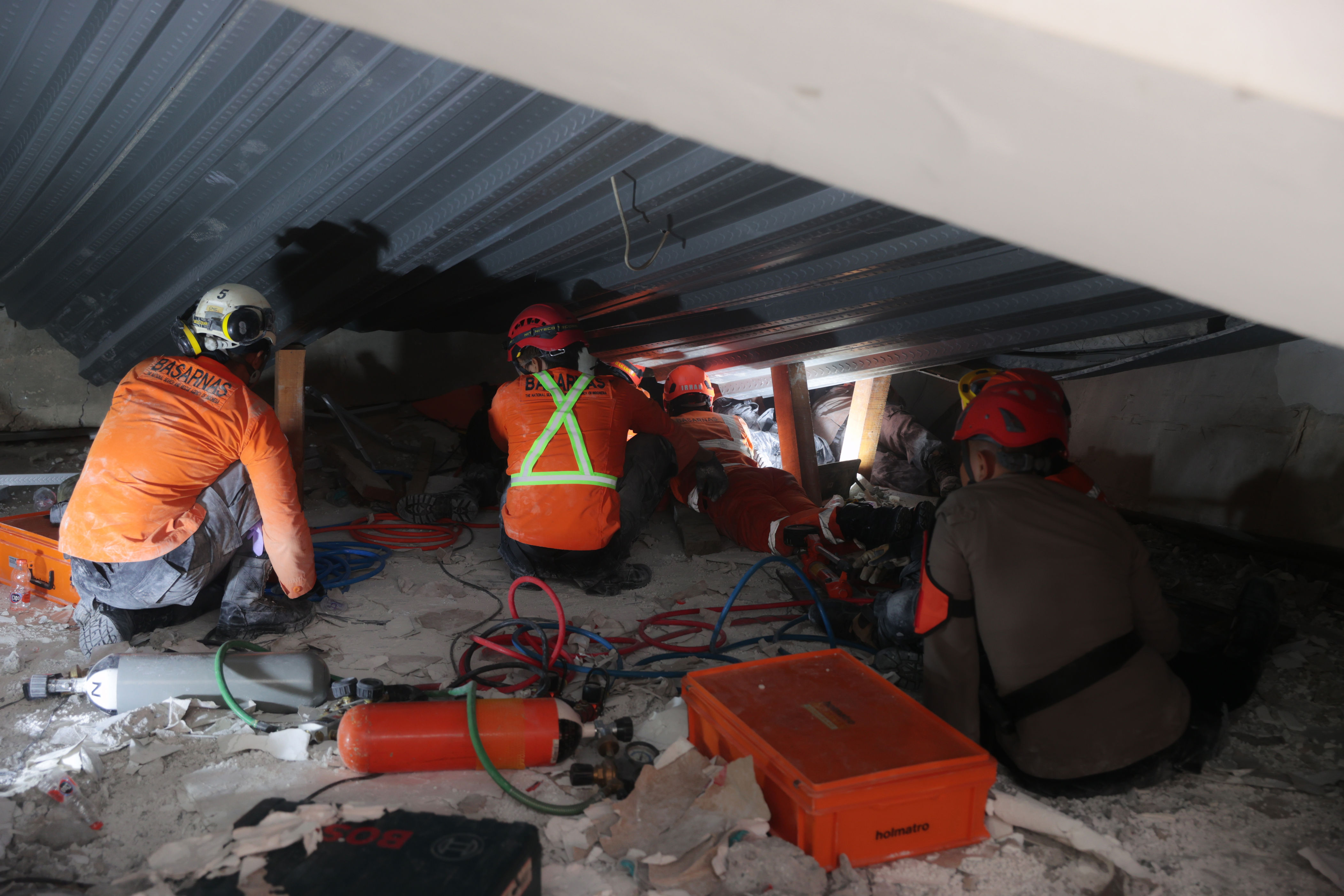 Rescuers search for survivors after school building collapses in Indonesia