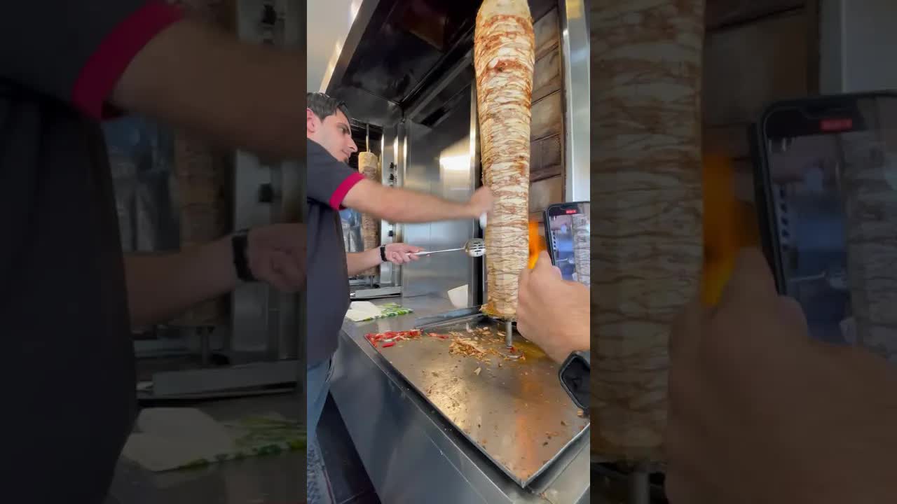 Iraqi shawarma master carving in Baiji, Iraq