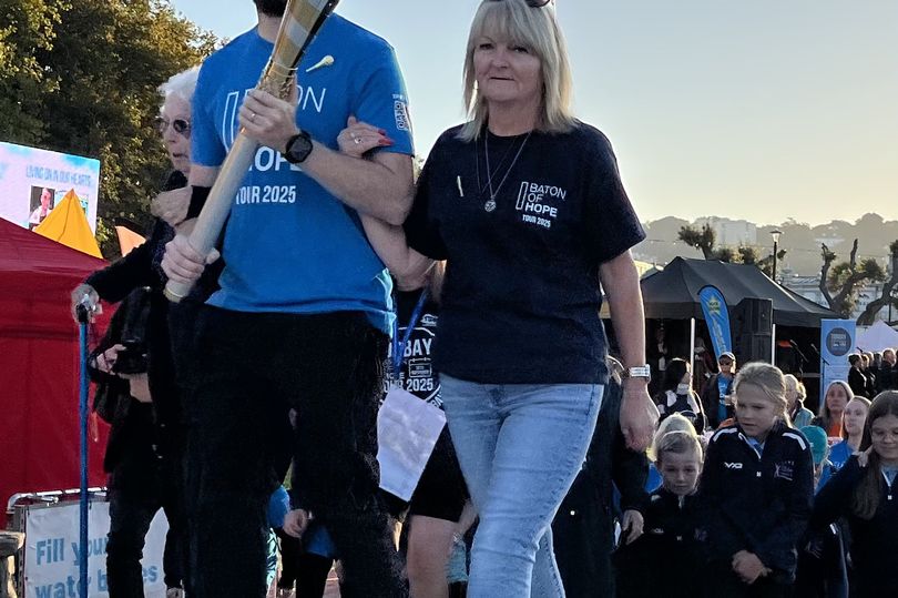 Powerful beacon carried through Torbay by 100 locals