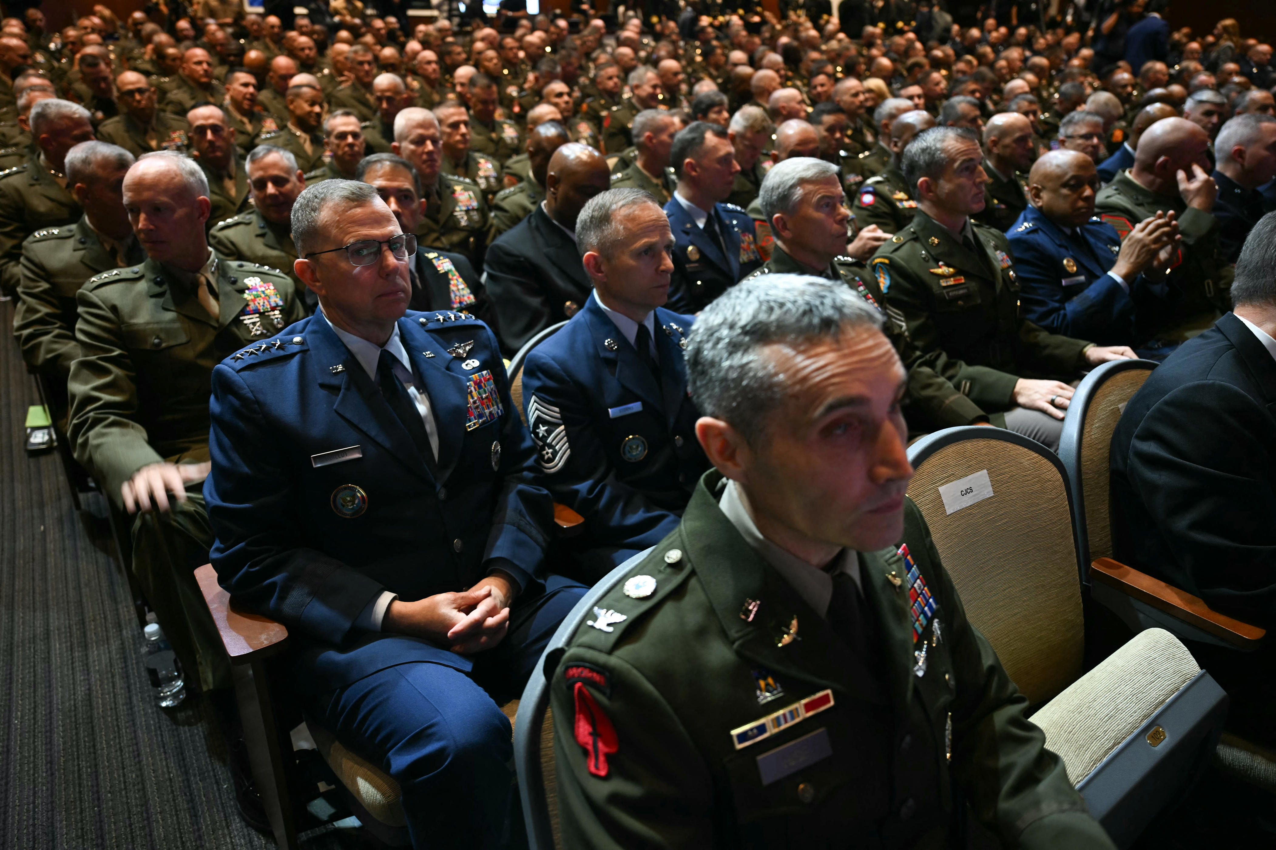 Trump threatens demotions at military summit