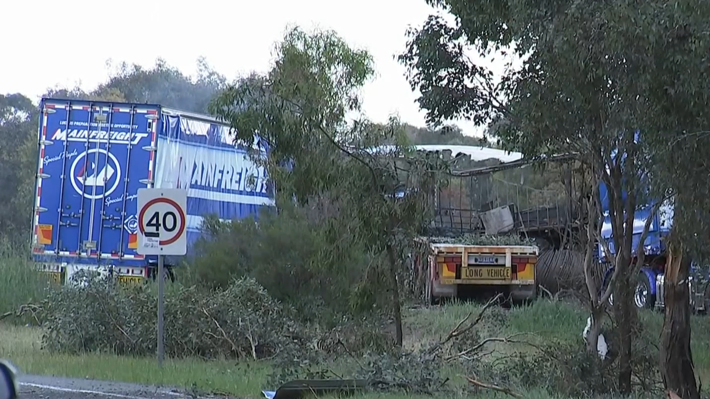 One dead after driver crashes into parked trucks as people slept inside