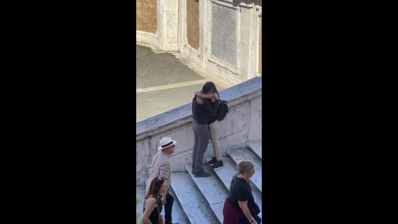 Couple kiss on famous steps in Italy