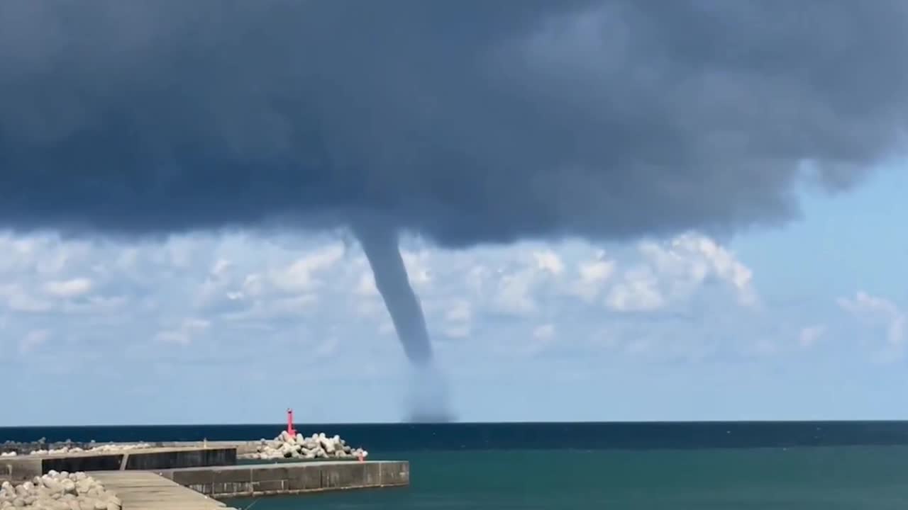 Waterspout tornado swirls over sea off Japan coast