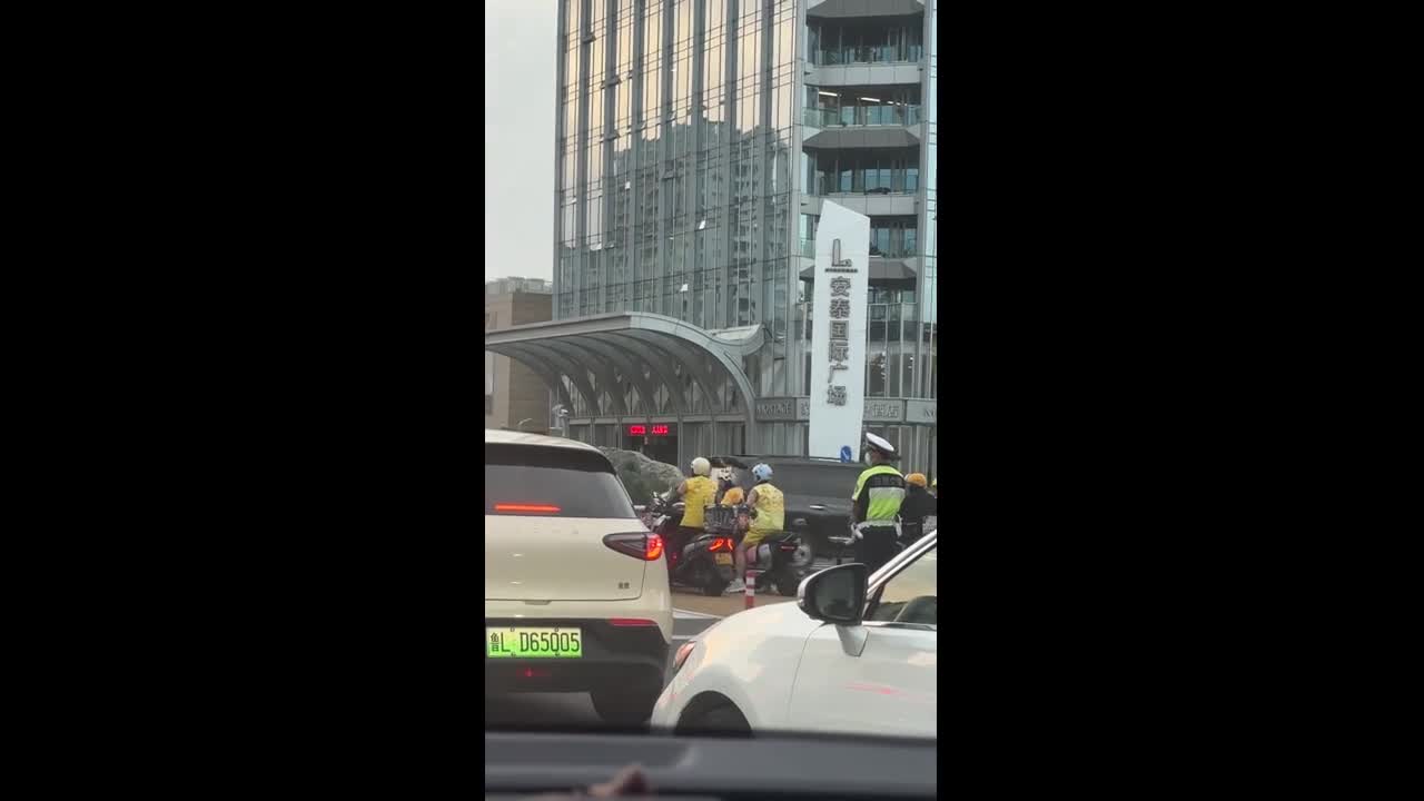 Happy scooter riders waiting at traffic light in Shandong, China