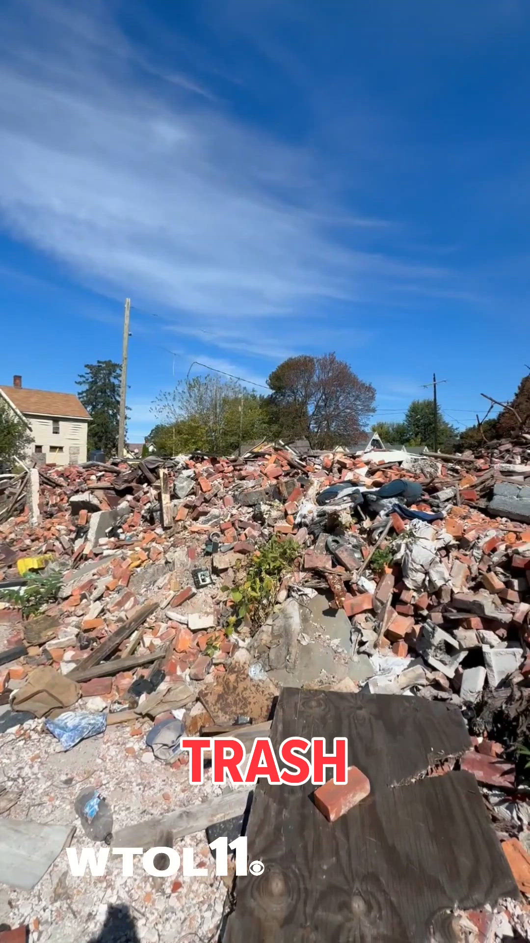 Community members waiting on cleanup for massive trash heap following fire