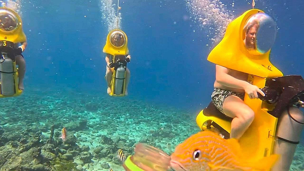 Friends ride underwater scooters in Curaçao waters
