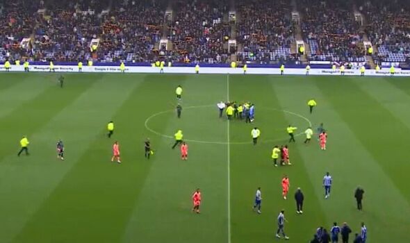 Championship match suspended as furious fans storm pitch after just 10 ...