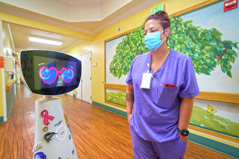 A robot programmed to act like a 7-year-old girl works to combat fear ...