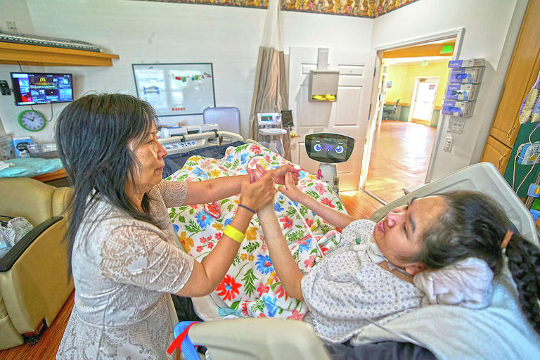 A robot programmed to act like a 7-year-old girl works to combat fear ...