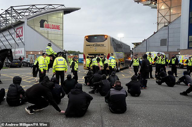 Furious Rangers fans barricade team bus as Martin is given a police ...