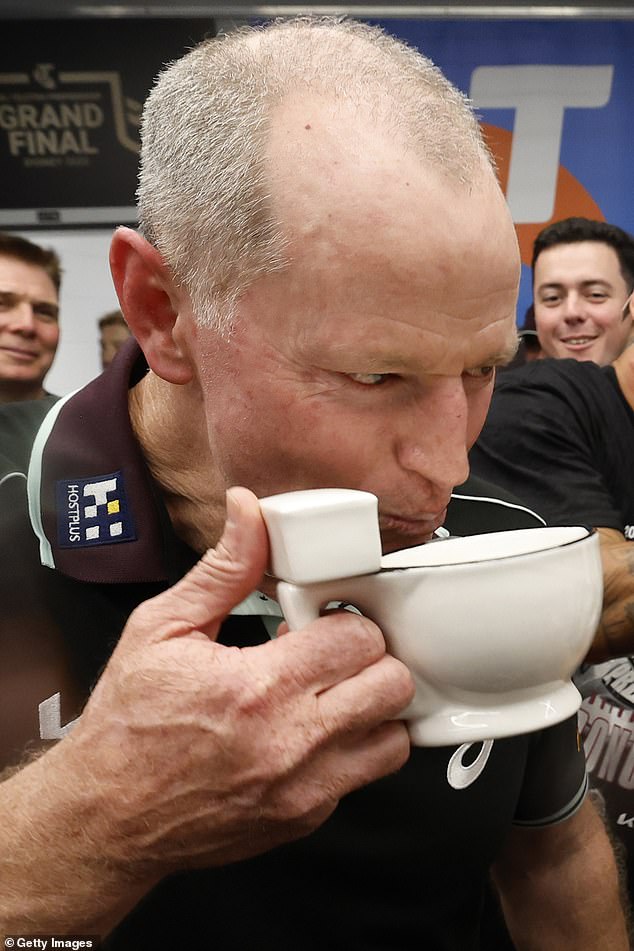 Broncos coach Michael Maguire drinks from a toilet as Reece Walsh joins ...