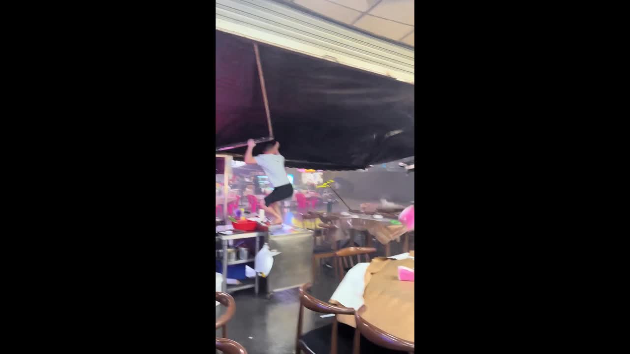 Typhoon Matmo batters the outdoor restaurant in China