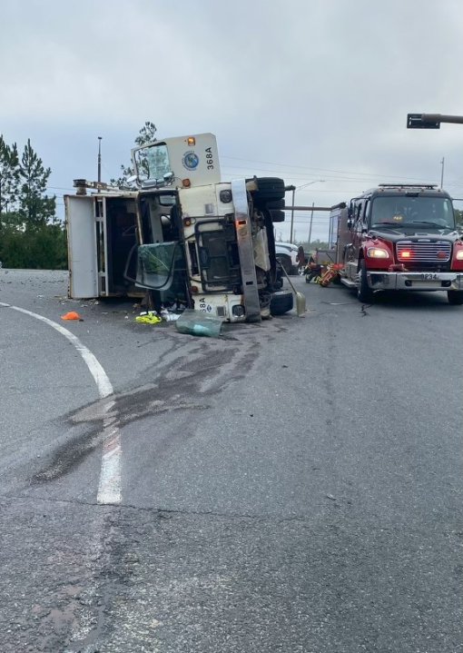 Minor injuries reported after garbage truck overturns