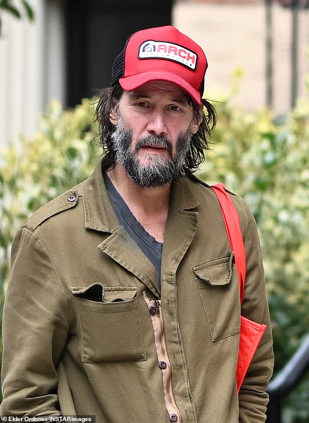 Scruffy Keanu Reeves cuts a lonely figure after being forced to deny ...