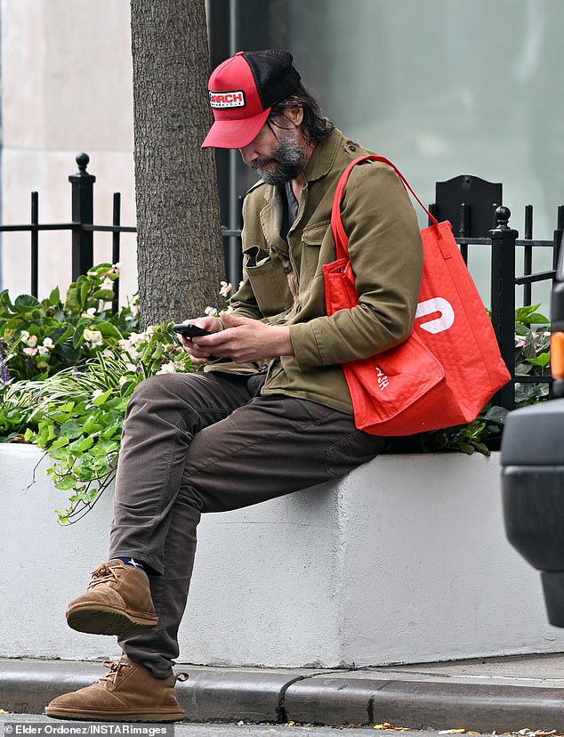 Scruffy Keanu Reeves cuts a lonely figure after being forced to deny ...