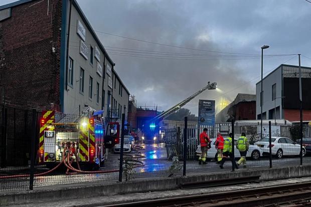 Fire crews battle blaze which broke out at Oldham business park in ...