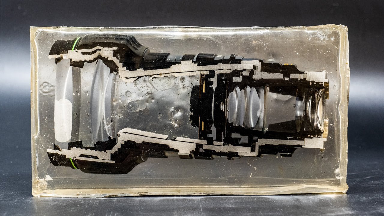 1996 camera lens cast in epoxy resin and cut in half