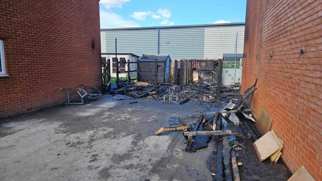 Battery charger fire damages homes and wrecks sheds
