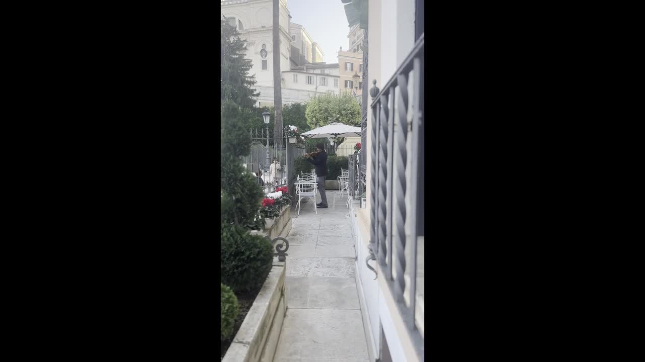 Violinist plays sad song at famous steps in Italy