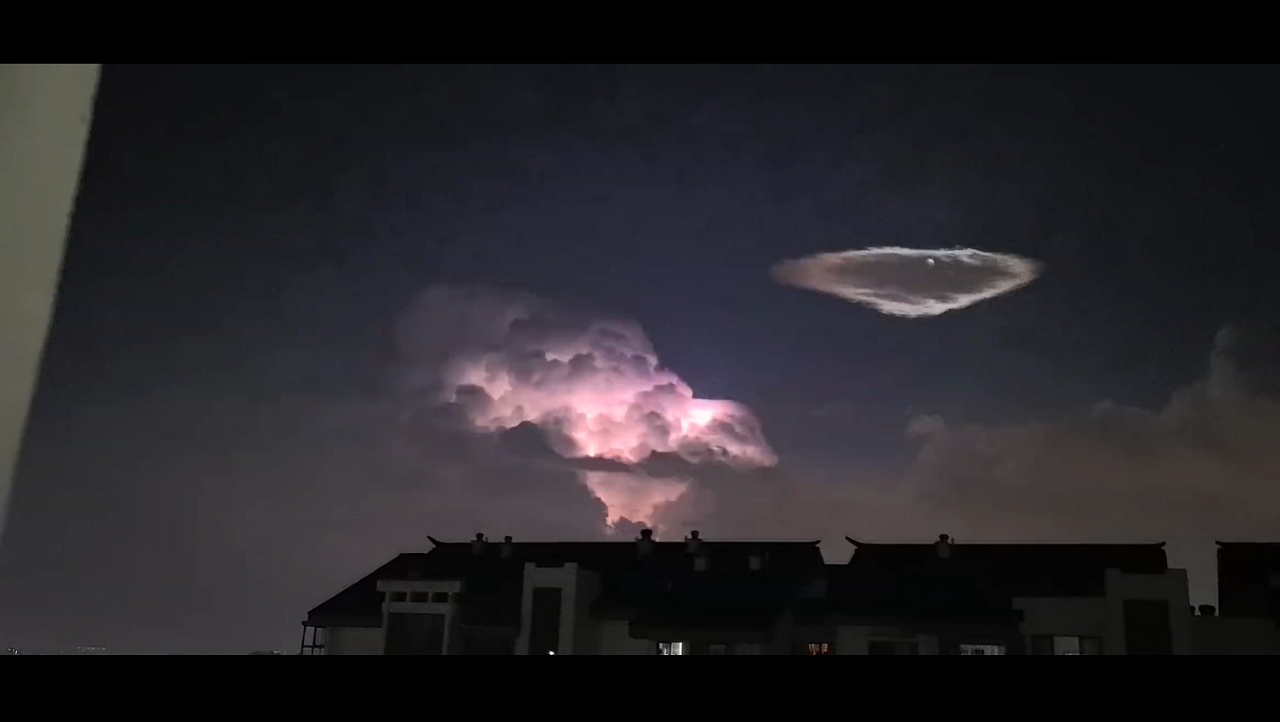 Lightning bolts illuminate thunderstorm clouds in Beijing, China