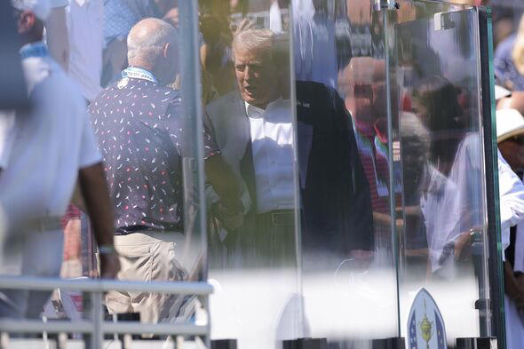 Donald Trump stands behind bulletproof glass at Ryder Cup as everyone ...