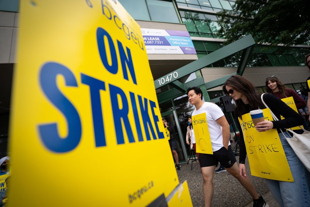 Hundreds of striking public sector workers march in downtown Vancouver