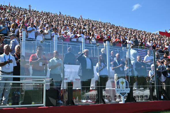 Donald Trump stands behind bulletproof glass at Ryder Cup as everyone ...