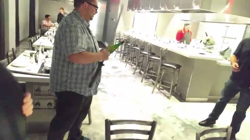 Man Tries to Pop Open Champagne Bottle with Sword