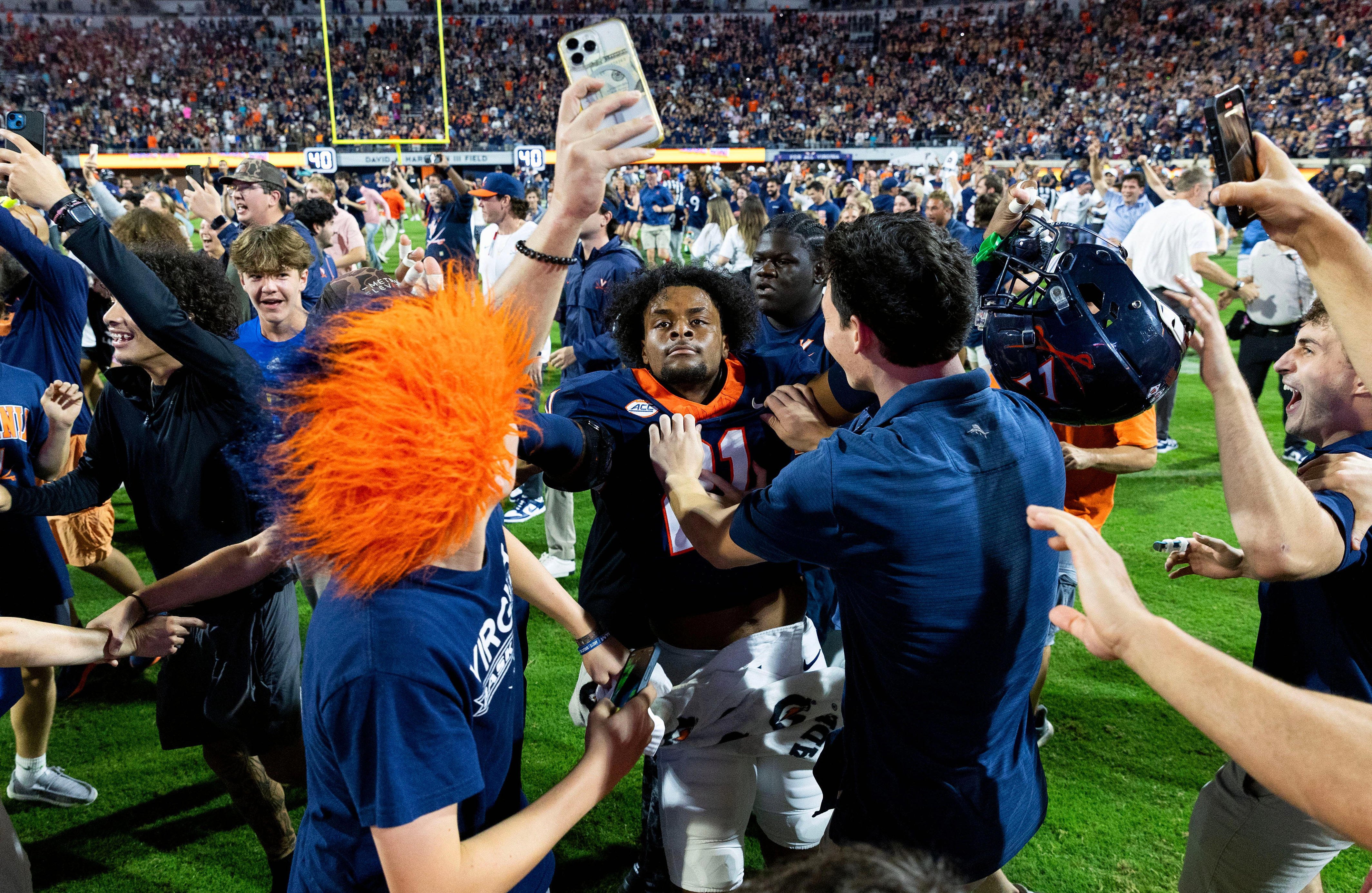 Check out the best photos from Virginia fans storming field after upset ...