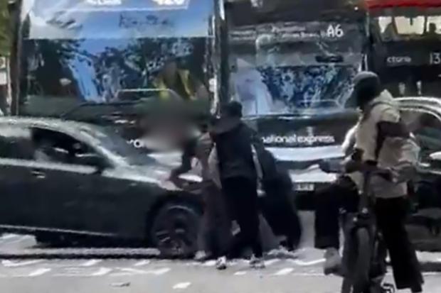 Man arrested after car rams into group brawl in busy London street with ...