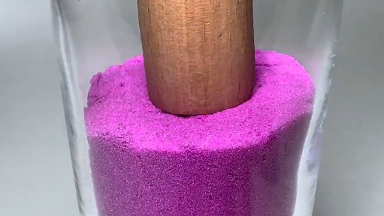 Satisfying pattern creation: Colorful kinetic sand layered smoothly ...