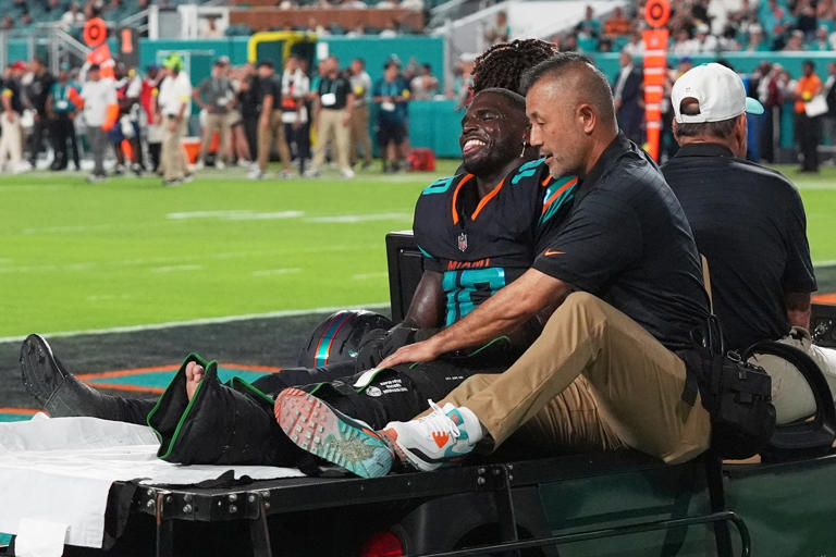 Dolphins' Tyreek Hill carted off field and taken to hospital with dislocated left knee