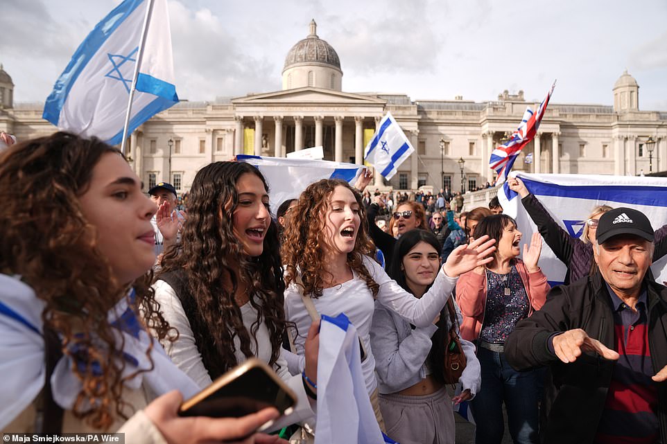 Woman cutting down Israeli hostage ribbons confronted