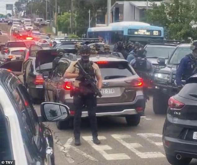 Heavily armed tactical police stop traffic and open fire on black Mercedes
