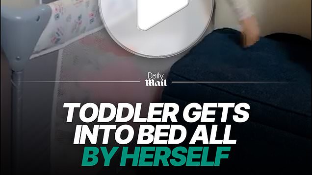 Clever toddler tucks herself into her cot