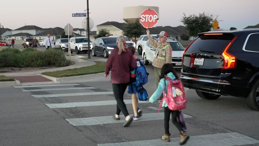 School crossing guard calls for road safety improvements