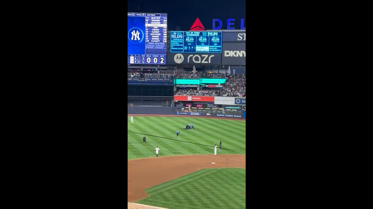 2 fans rush the field during Game 3 of ALDS