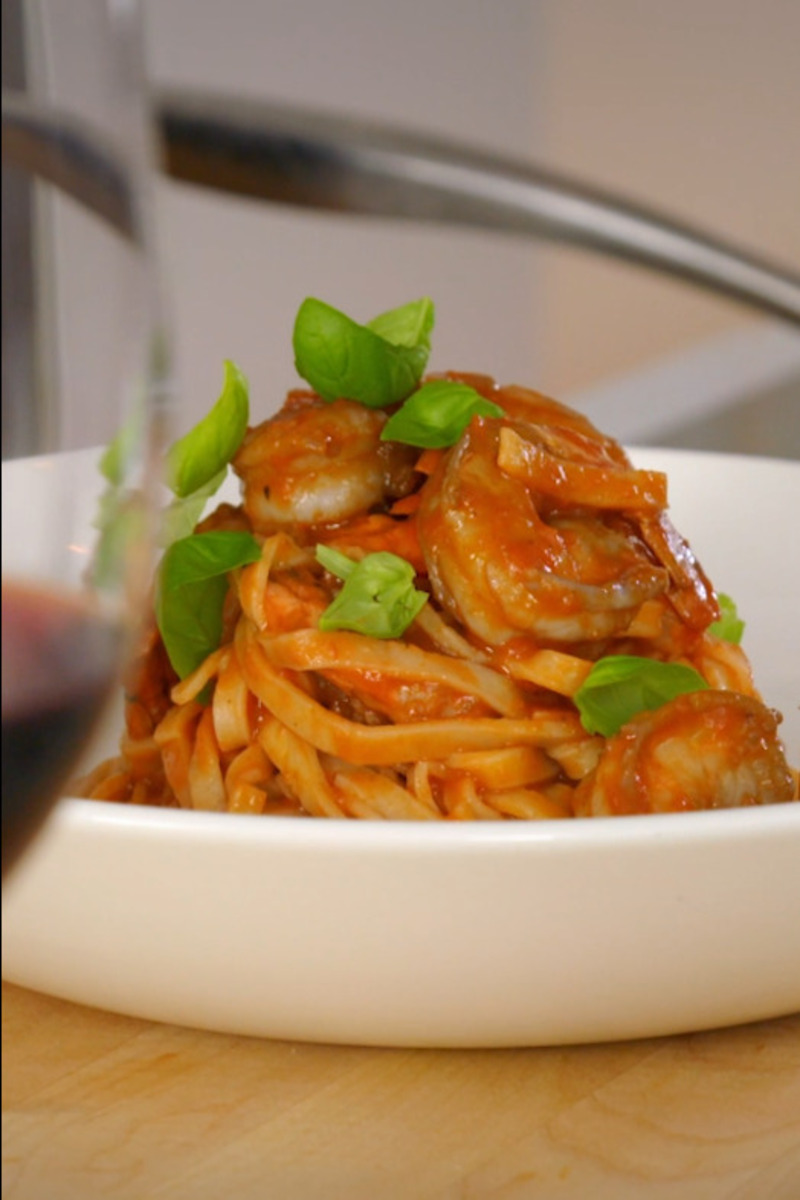Fresh linguine with prawns, tomato sauce, and basil