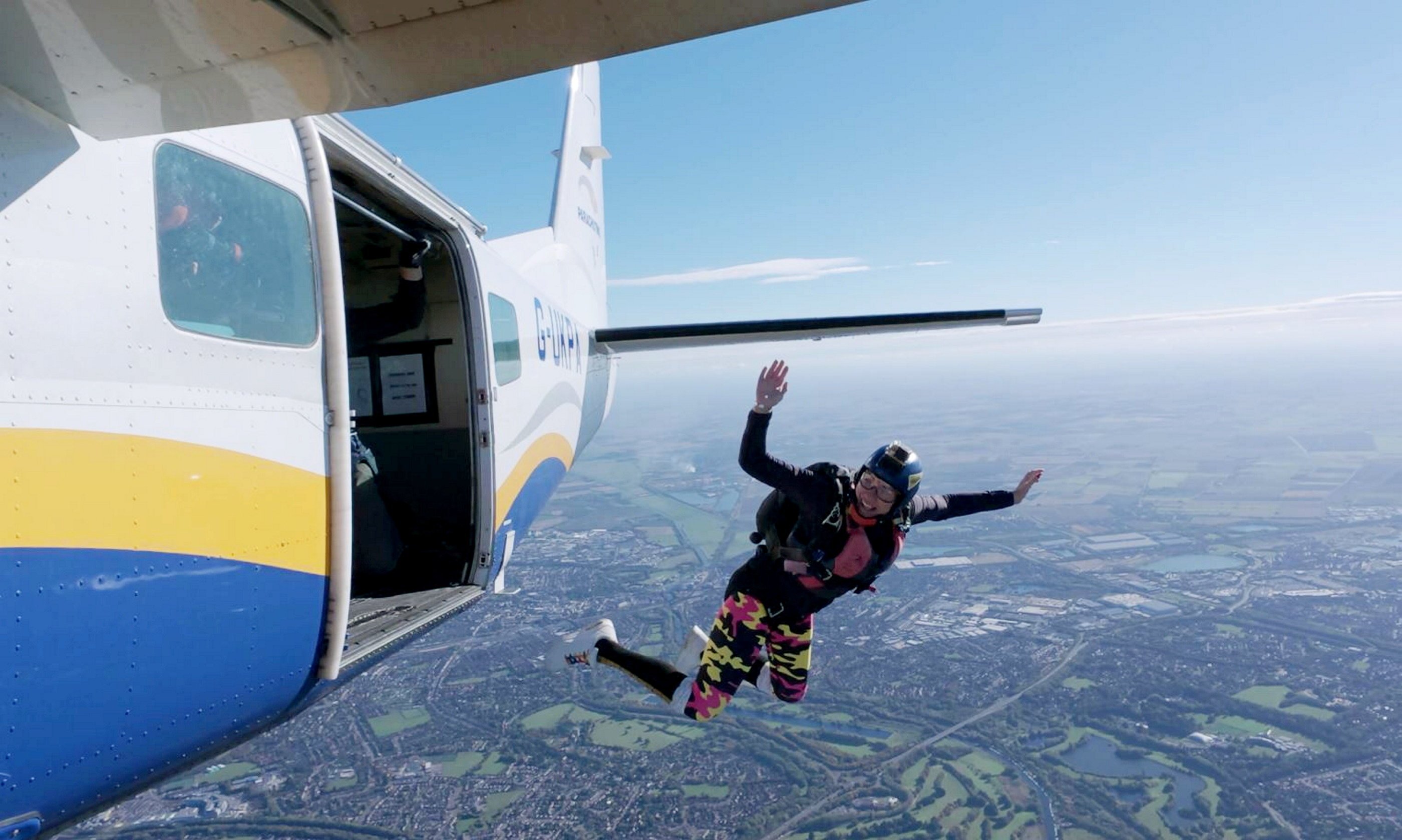 Group of 17 skydivers perform rare 'water drop' plunge into lake at 100mph