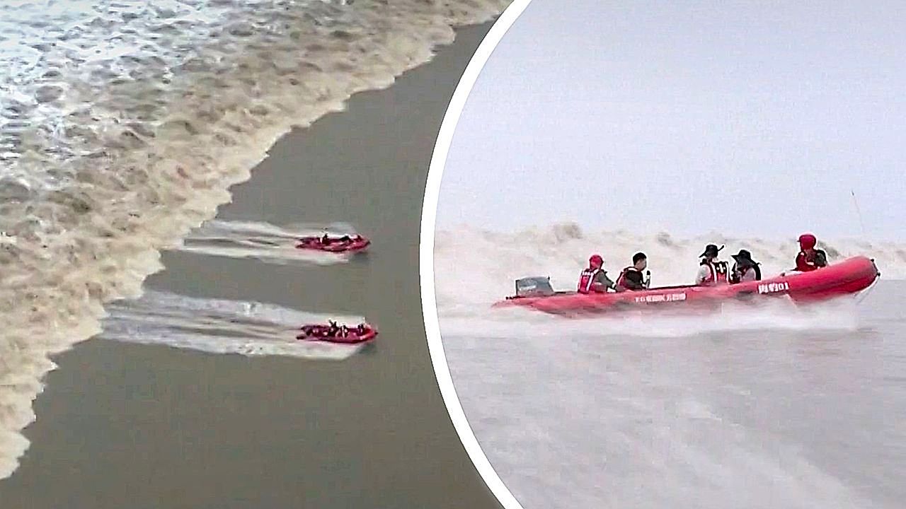 Dinghies race massive tidal bore on China's Qiantang River